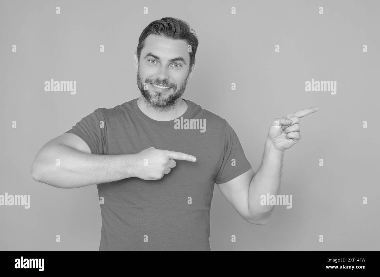 The point away. Happy handsome man pointing finger away, isolated pink ...