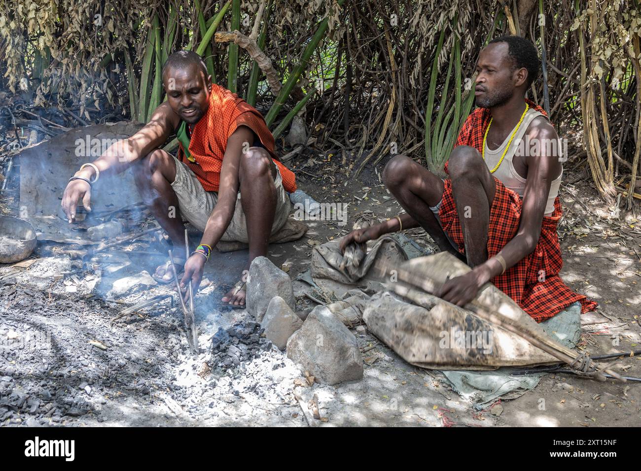 Blacksmitthing: melting pieces of scrap brass using bellows made from ...