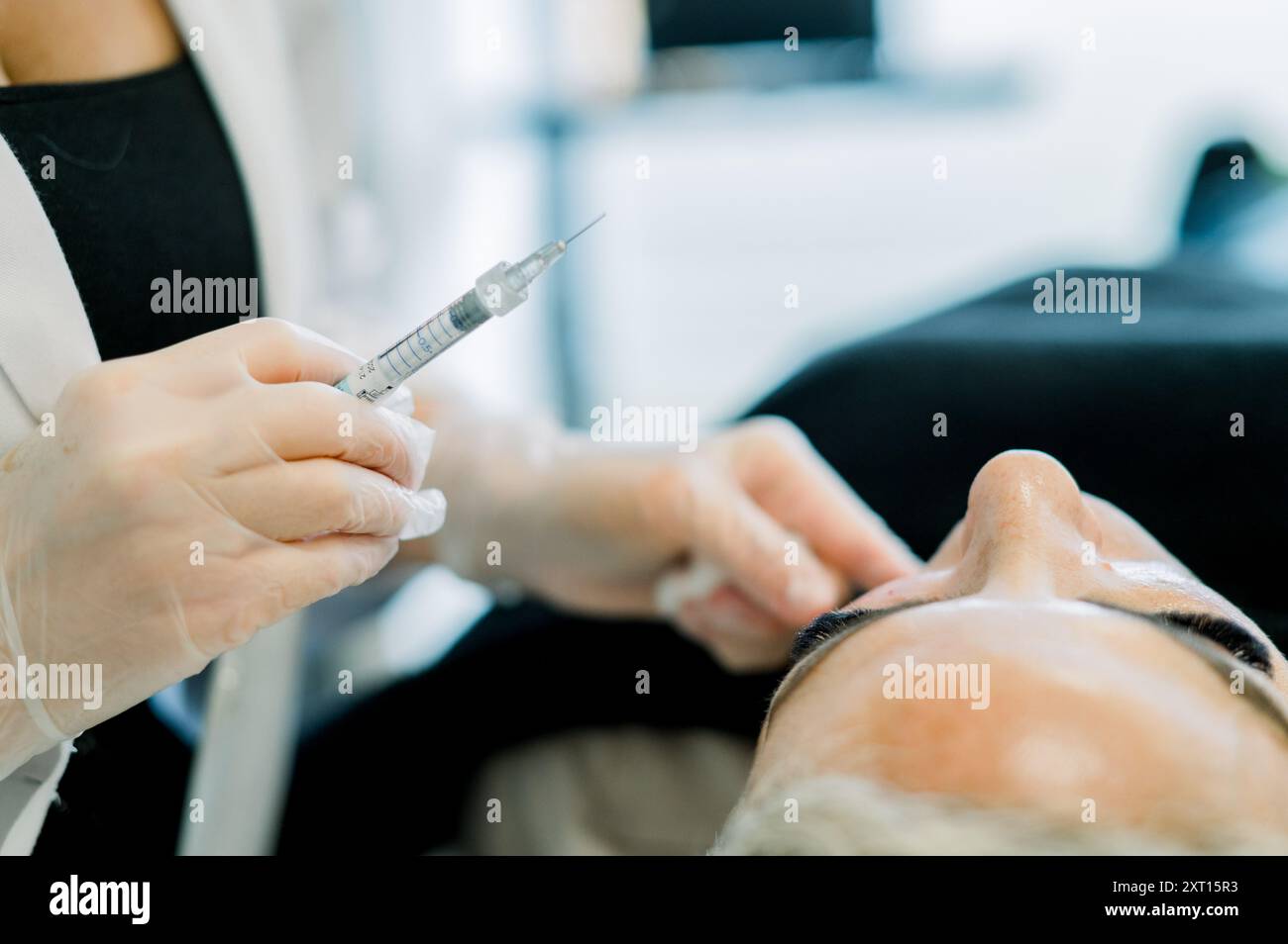 Close-up view of a cosmetic procedure with a professional administering ...