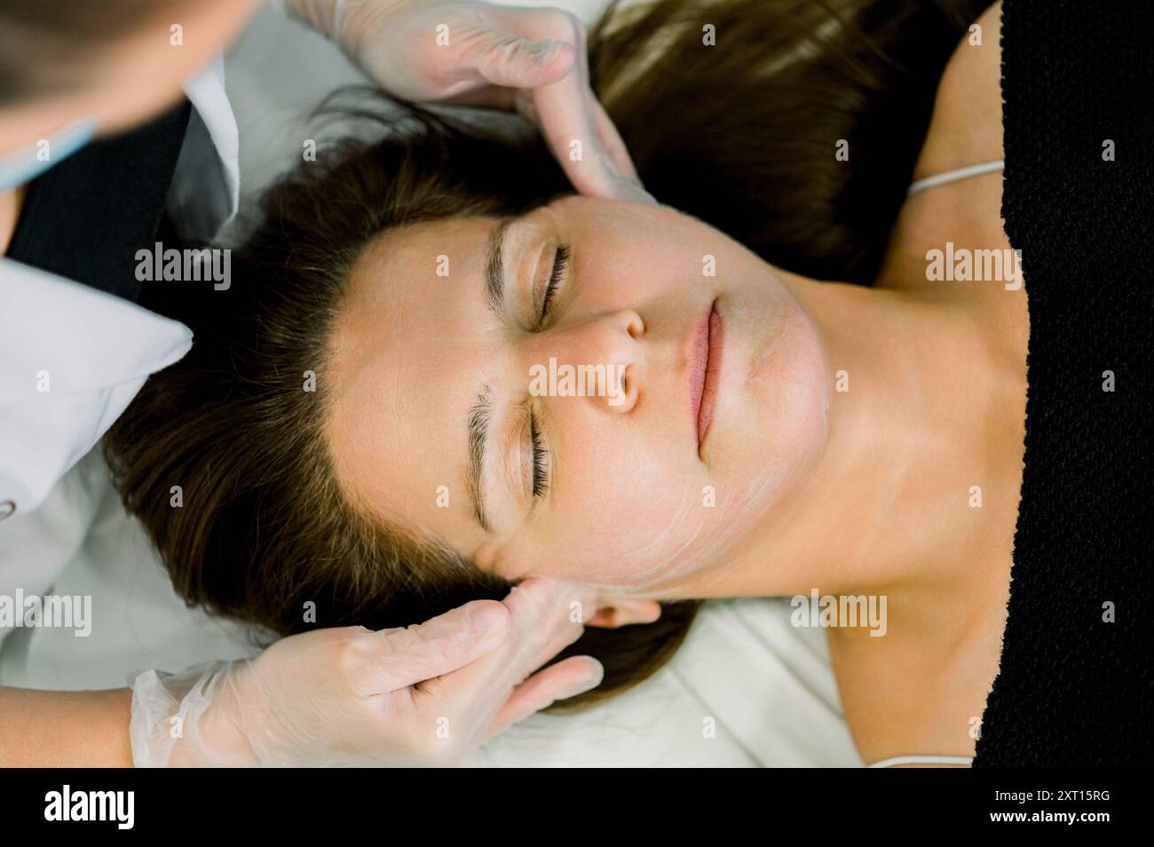Woman receiving a facial aesthetic treatment with hyaluronic acid ...