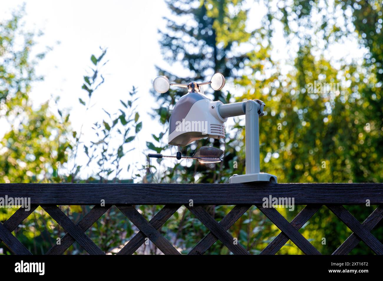 Wireless weather station is mounted on a wooden fence. Personal weather ...