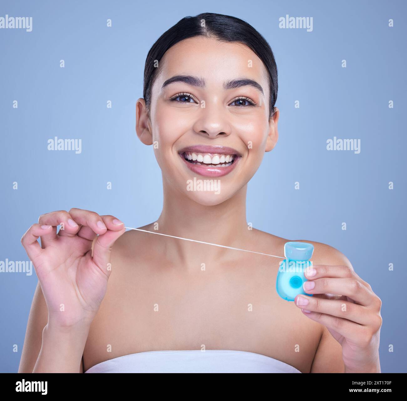 Dental floss, smile or portrait of woman in studio on blue background ...