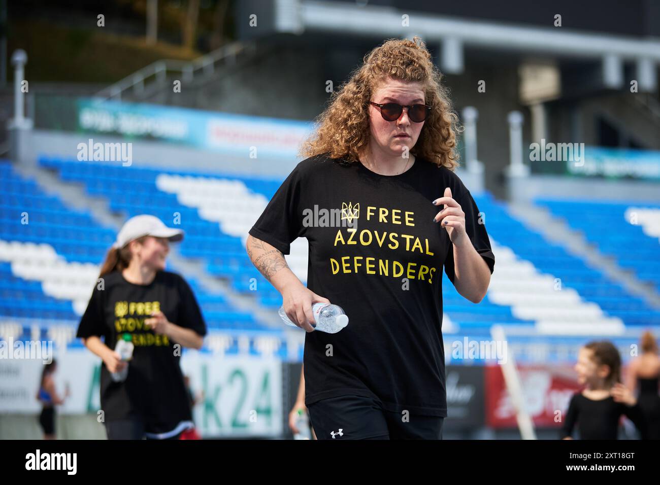 Ukrainian woman running wearing a shirt Free Azovstal Defenders ...