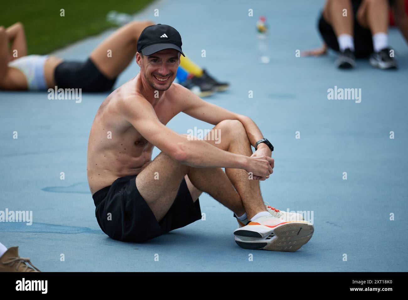 Skinny Ukrainian man resting between exercises during ground fitness ...