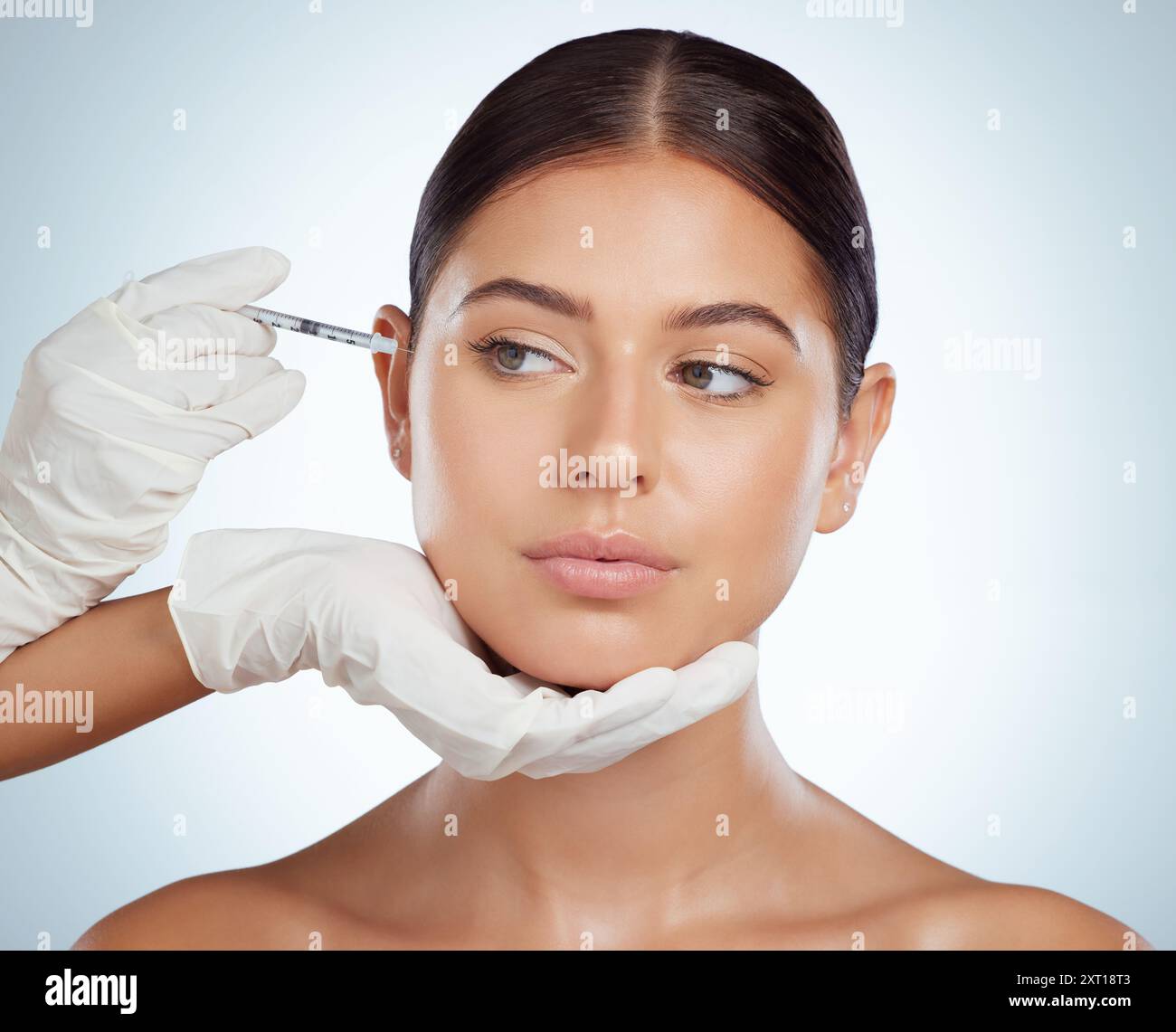 Woman, hands and injection for facelift in studio on white background ...