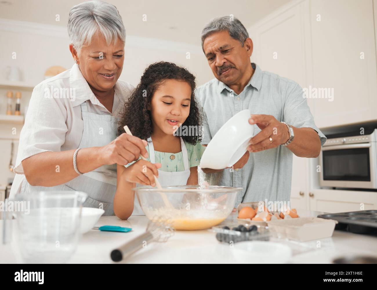 Mixing, kid and grandparents with baking in kitchen for helping ...