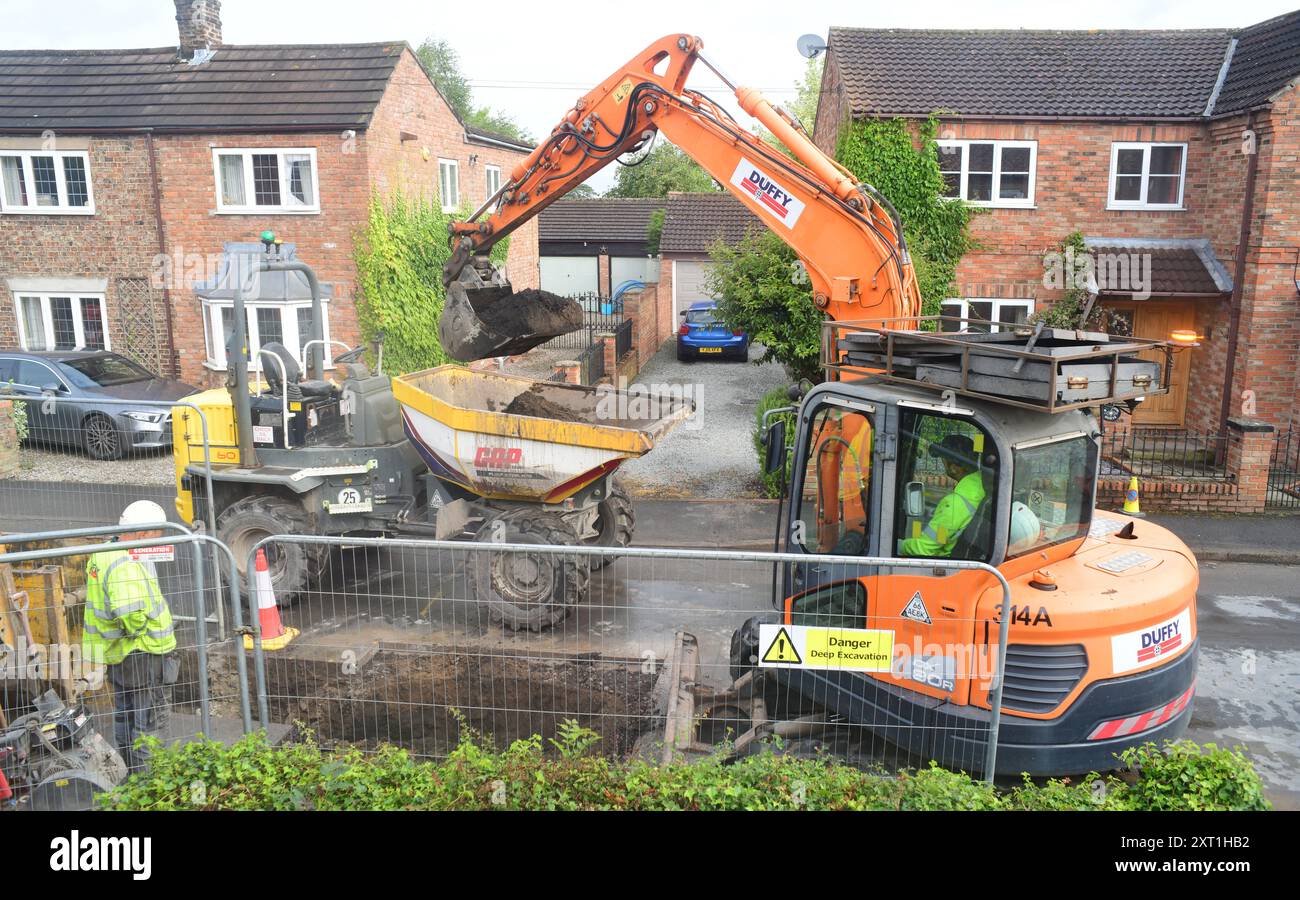 engineers installing new pipe line beneath high street to stop flooding ...