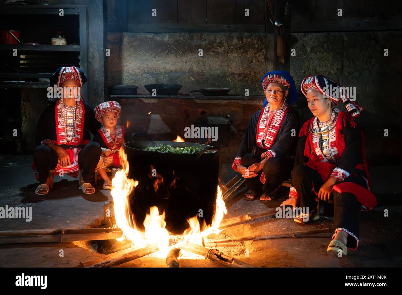 Three generations of a Red Dao hill tribe family cooking in their ...