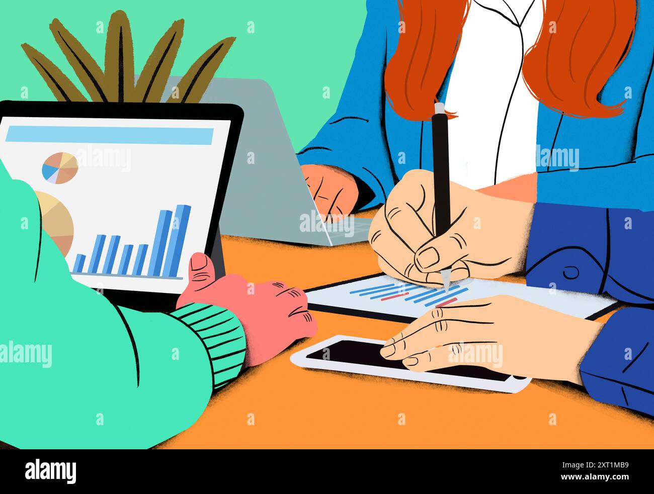 People collaborating at a desk with tablets, laptops, and documents ...