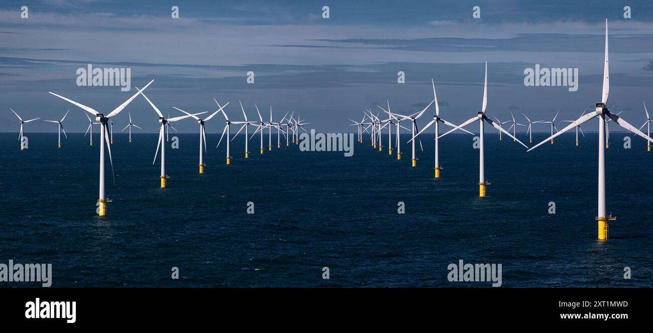 Offshore wind farm with rows of wind turbines in the ocean under a ...
