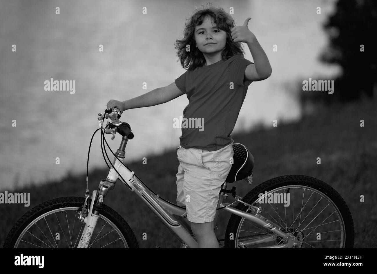 Little kid boy ride a bike in the park. Kid cycling on bicycle. Happy ...