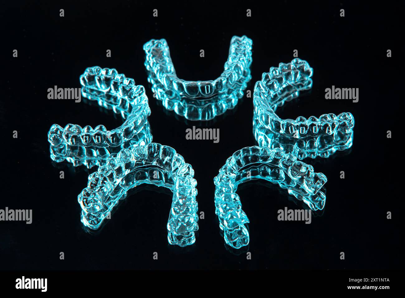 Invisible aligner teeth retainers lie on the mirror in orthodontic ...