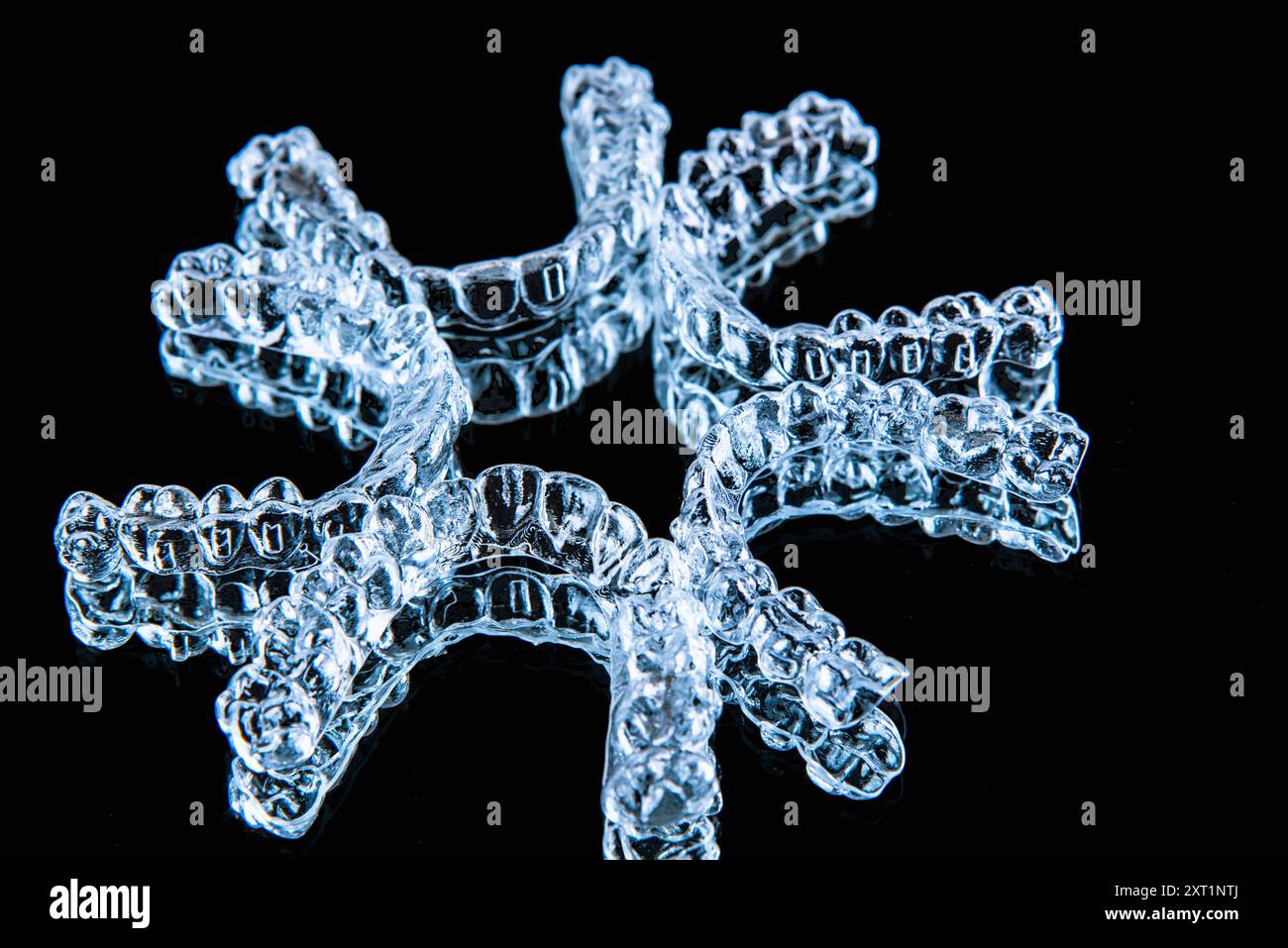 Invisible aligner teeth retainers on a black background Stock Photo - Alamy