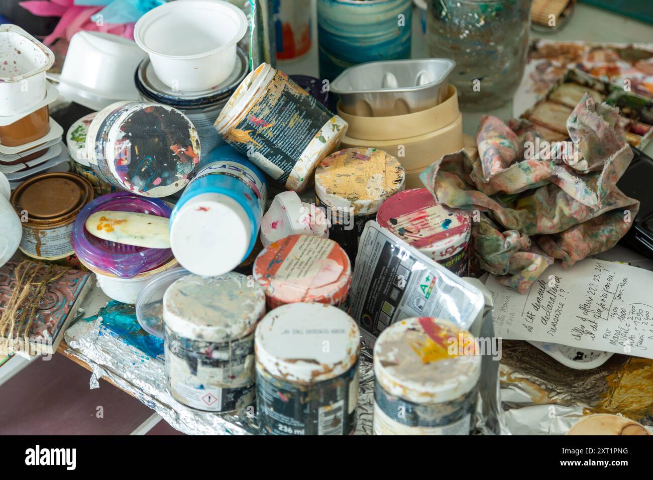 A messy collection of artists paint pots Stock Photo - Alamy