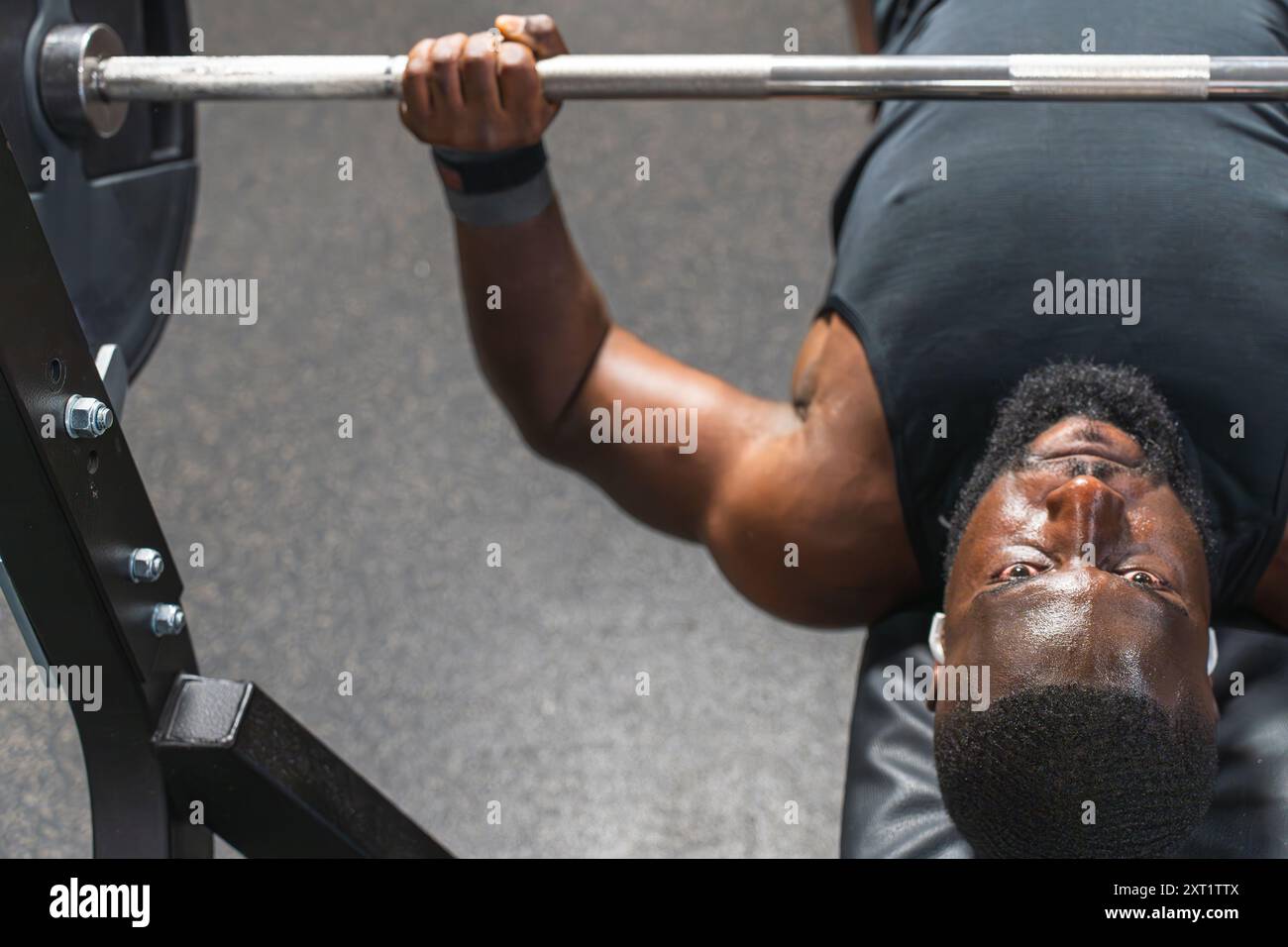 Black fitness trainer doing bench press in the gym Stock Photo - Alamy