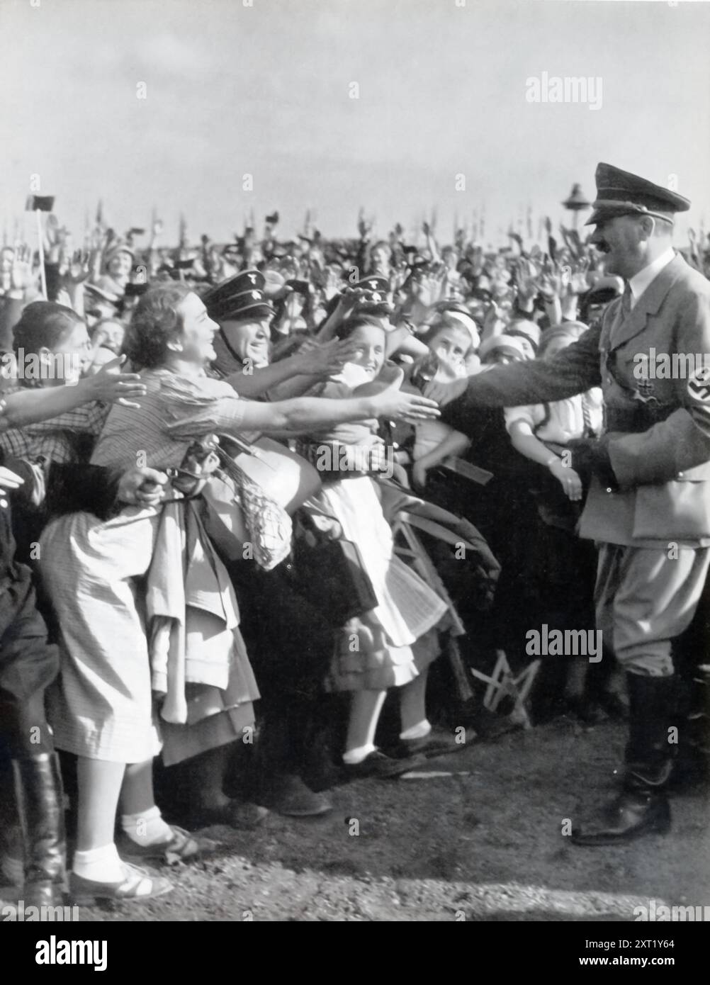 A photograph shows enthusiastic supporters meeting Adolf Hitler ...