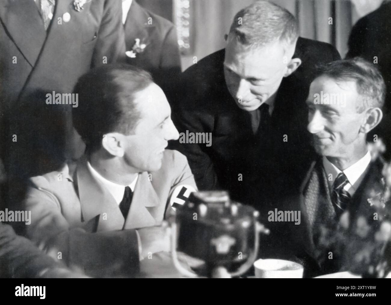 A photograph shows Reich Minister Dr. Joseph Goebbels engaging in a ...