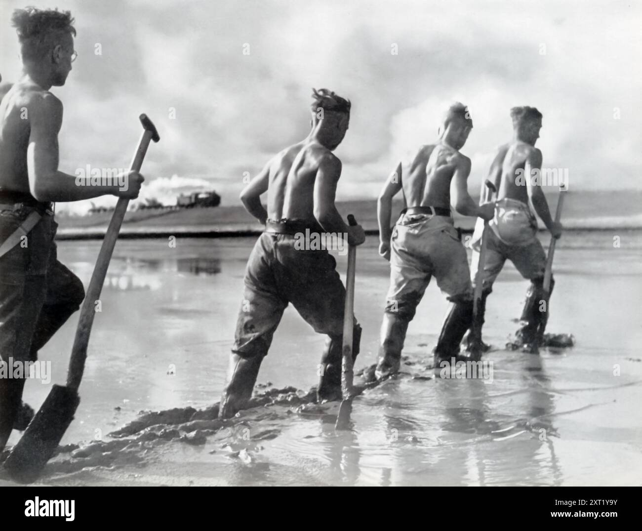 The photograph shows four young men from the Reich Labour Service ...