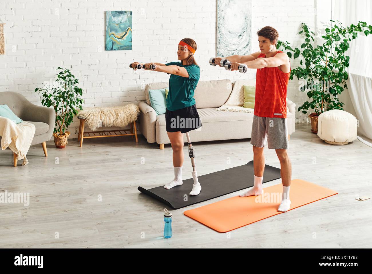 A woman with a prosthetic leg exercises with her boyfriend at home ...