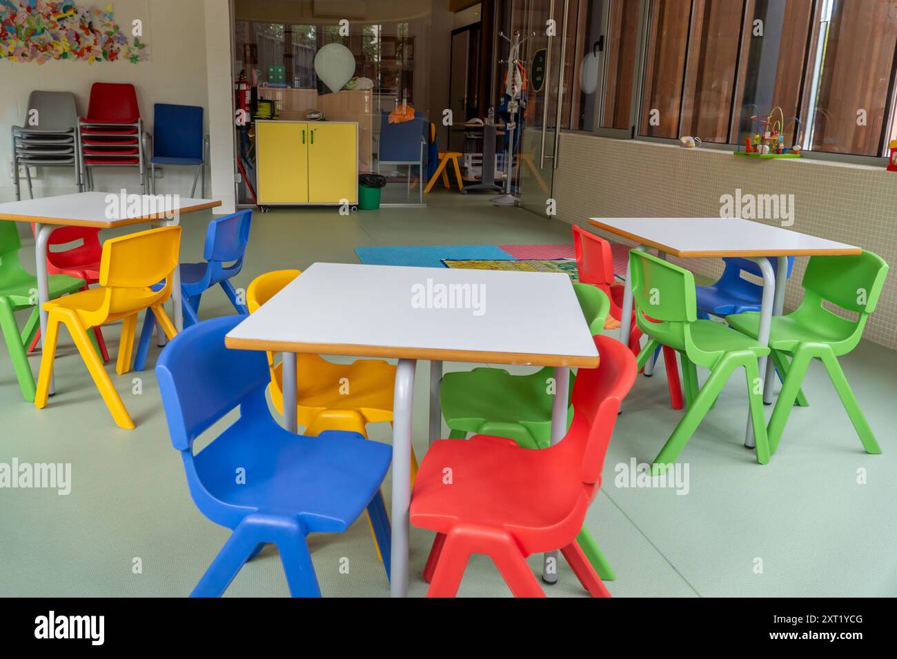 Elementary school classroom with multicolor chairs Stock Photo - Alamy