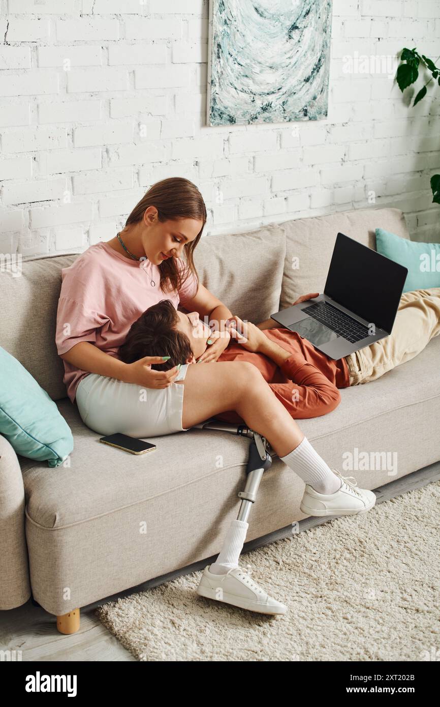 Woman with prosthetic leg rests head on boyfriends lap, he looks up ...