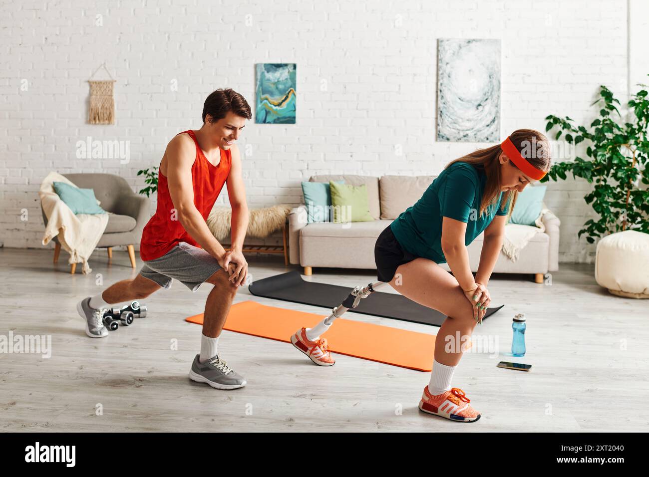 A woman with a prosthetic leg stretches with her boyfriend during an at ...