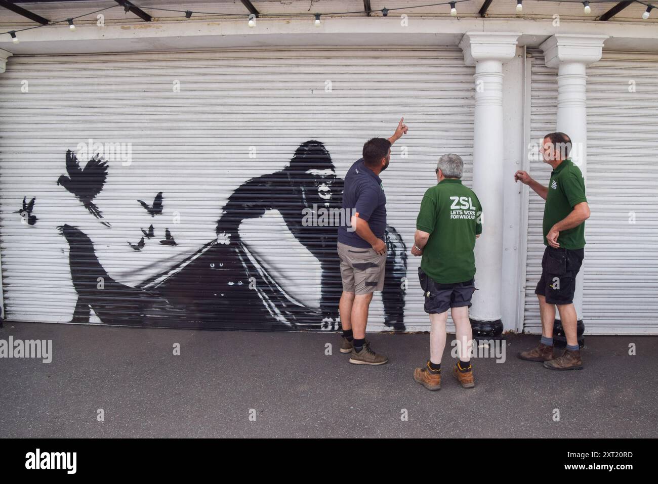 London, UK. 13th August 2024. Zoo staff inspect the new artwork by ...