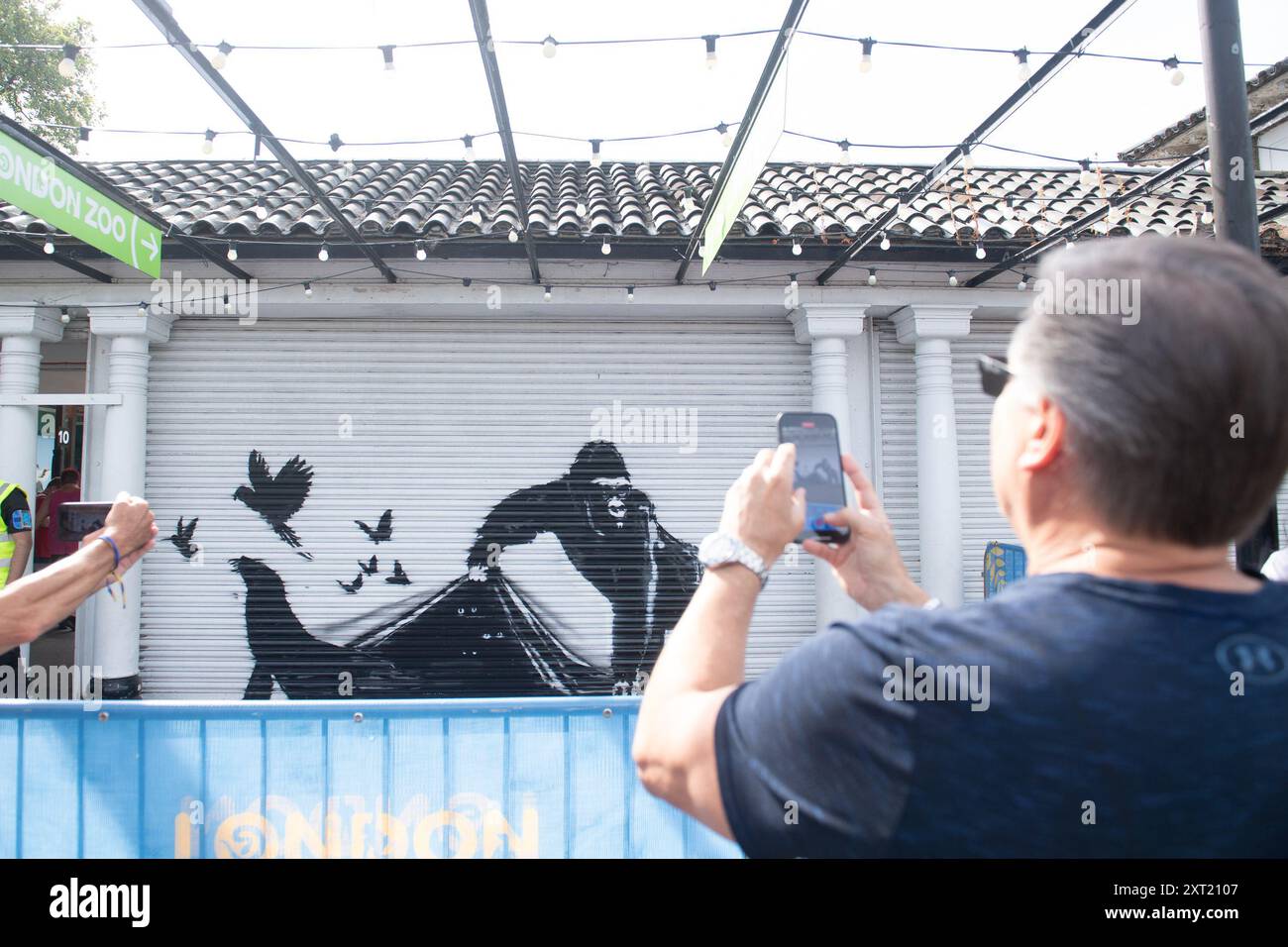 London, UK. 13 Aug 2024. People take photos of Street artist Banksy's ...