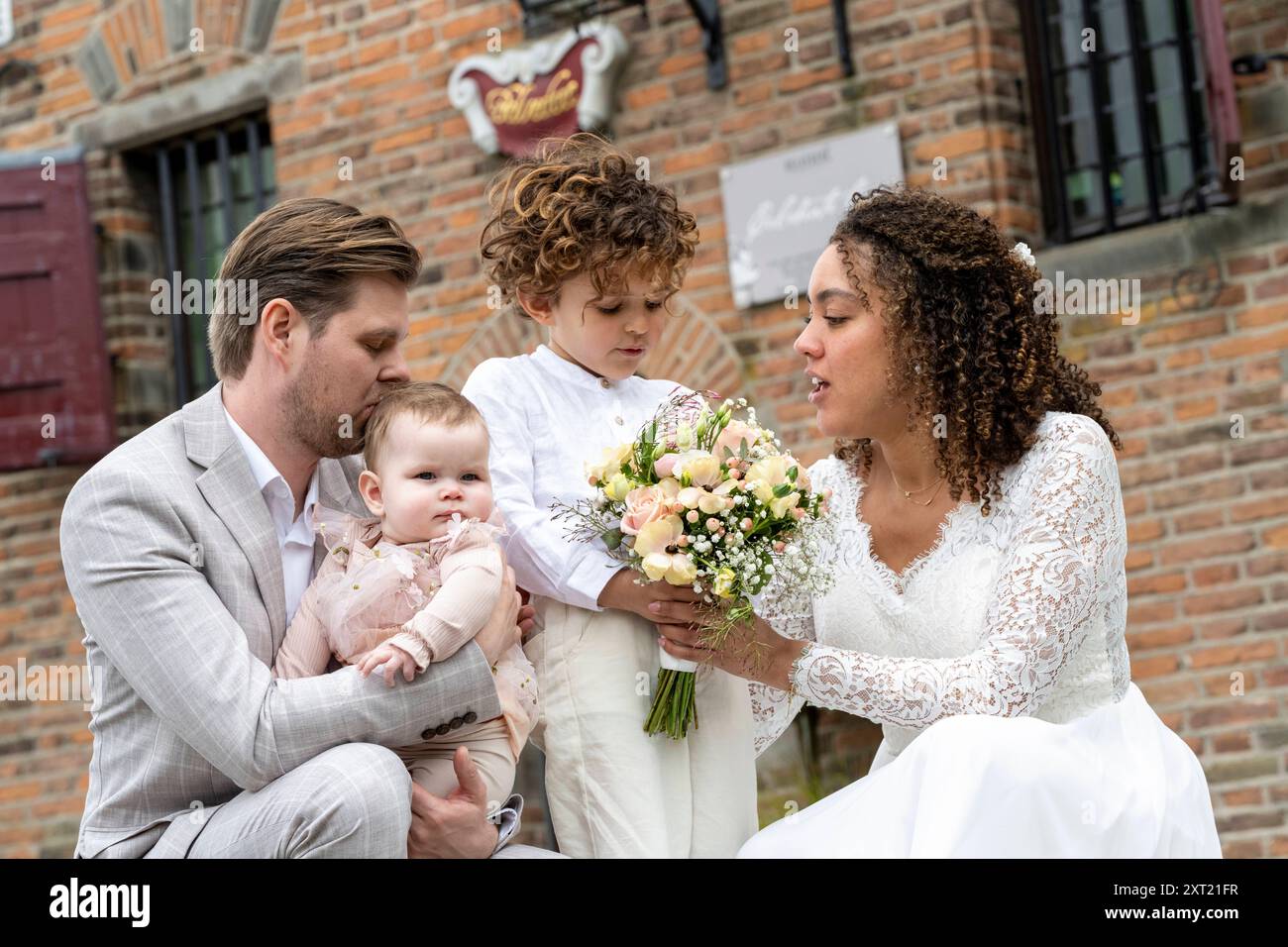 A family dressed in formal attire is posing for a picture outside a ...