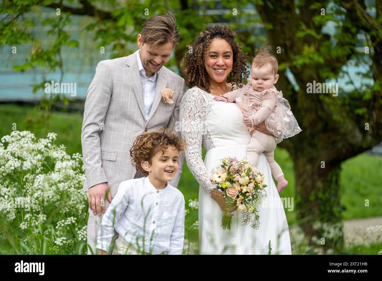 A happy family with two children celebrates a special occasion outdoors ...