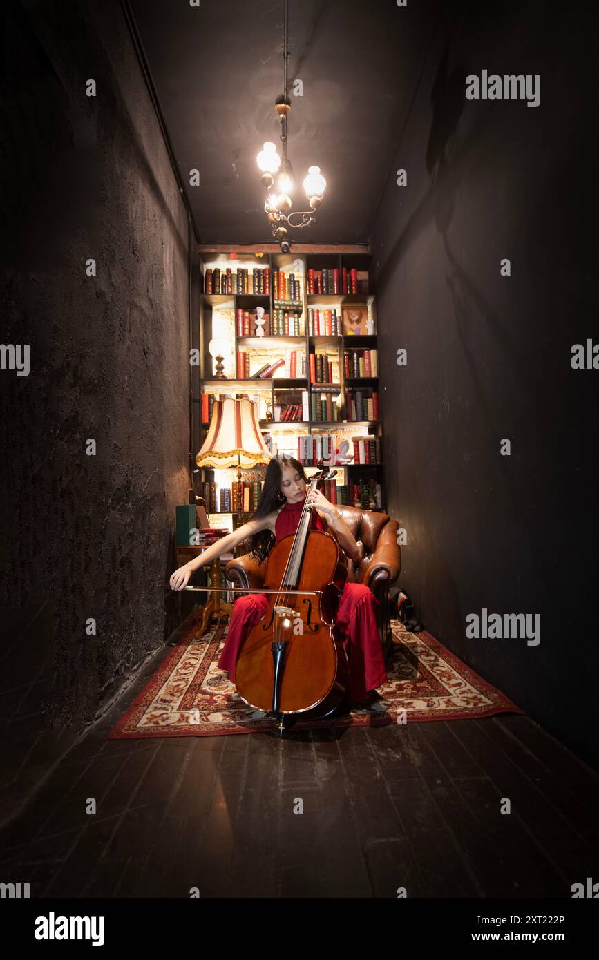 Asain musician playing the Cello in beautiful room Stock Photo - Alamy