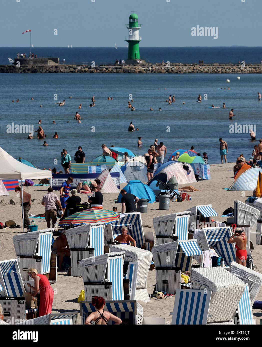 13 August 2024, Mecklenburg-Western Pomerania, Warnemünde: Swimmers ...