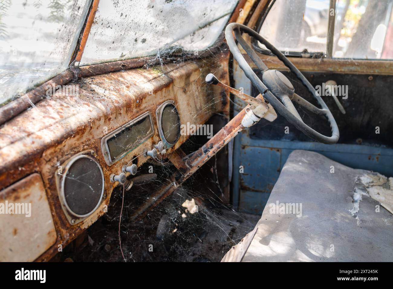 Abandoned old rusty car interior with dashboard and steering wheel ...