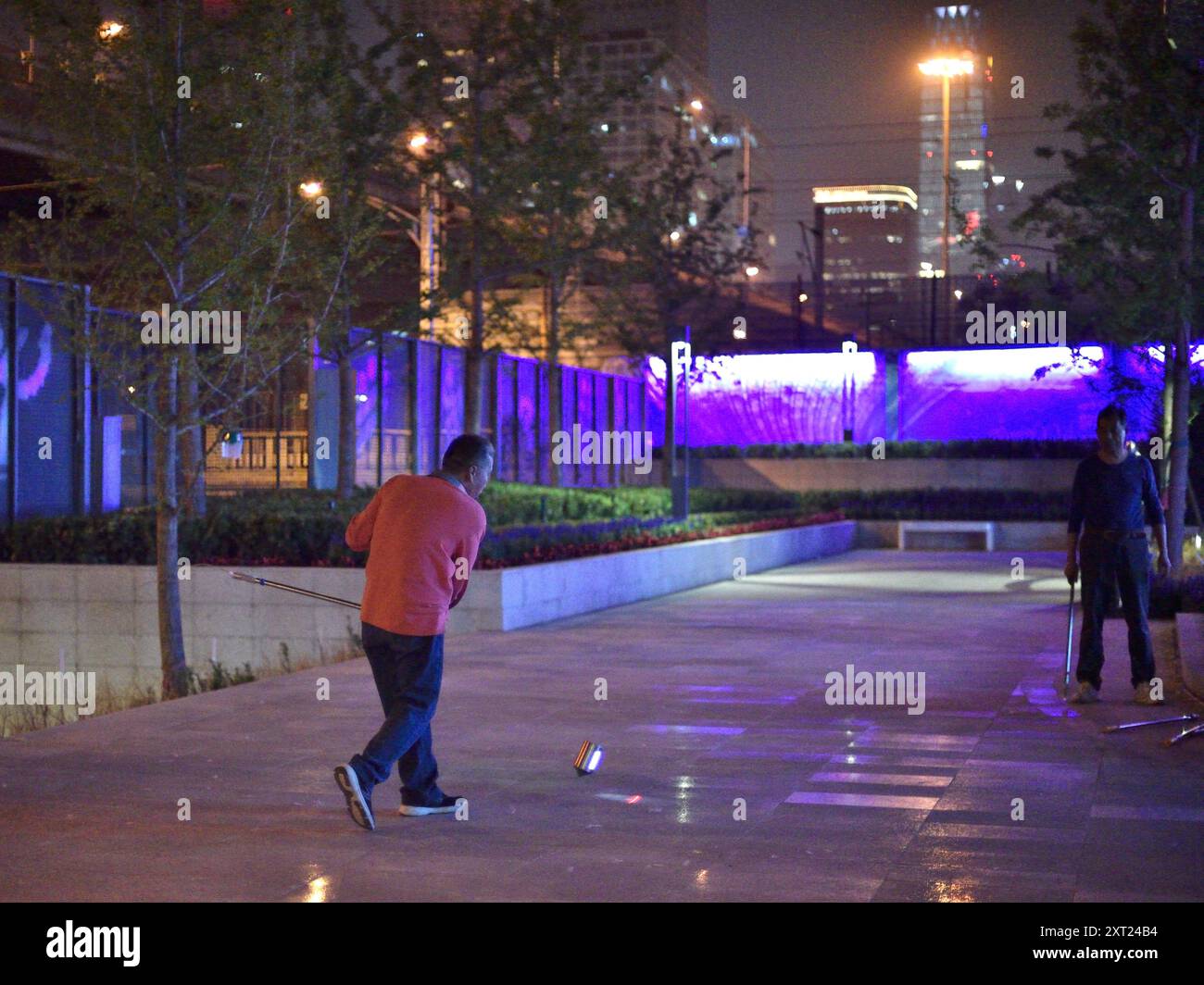 Chinese man whipping spinning tops, a traditional Chinese game in which ...