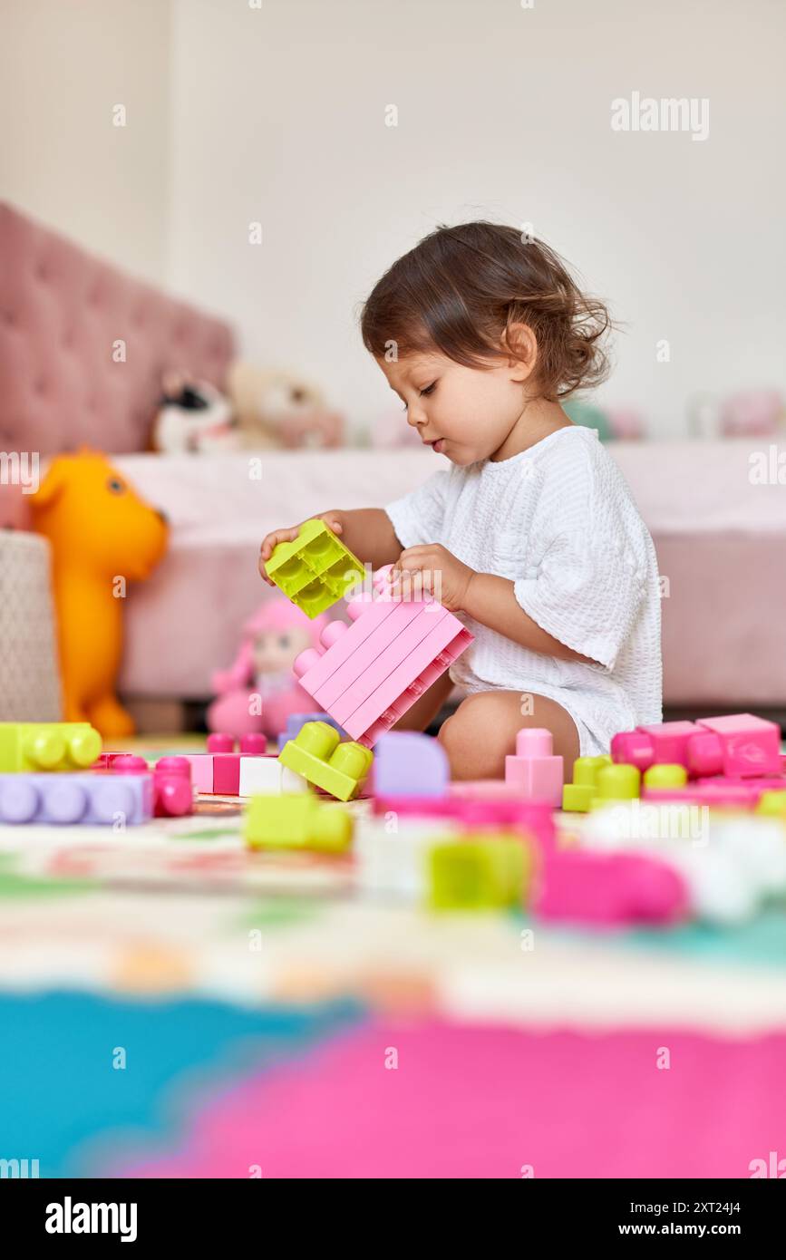 cute baby girl playing with colorful bright cubes at home Stock Photo ...