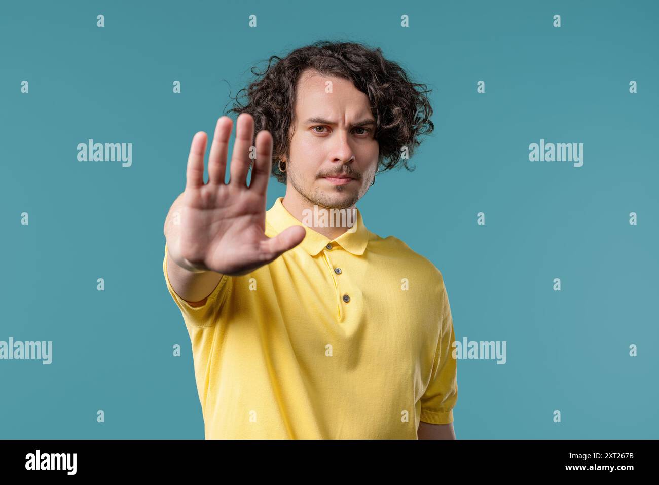 Serious man showing rejecting gesture by stop palm sign. Not allow ...