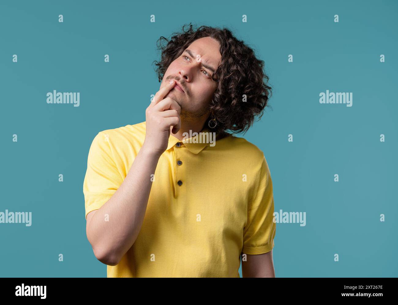 Curious thinking around curly man on blue. Confused student guy finding ...