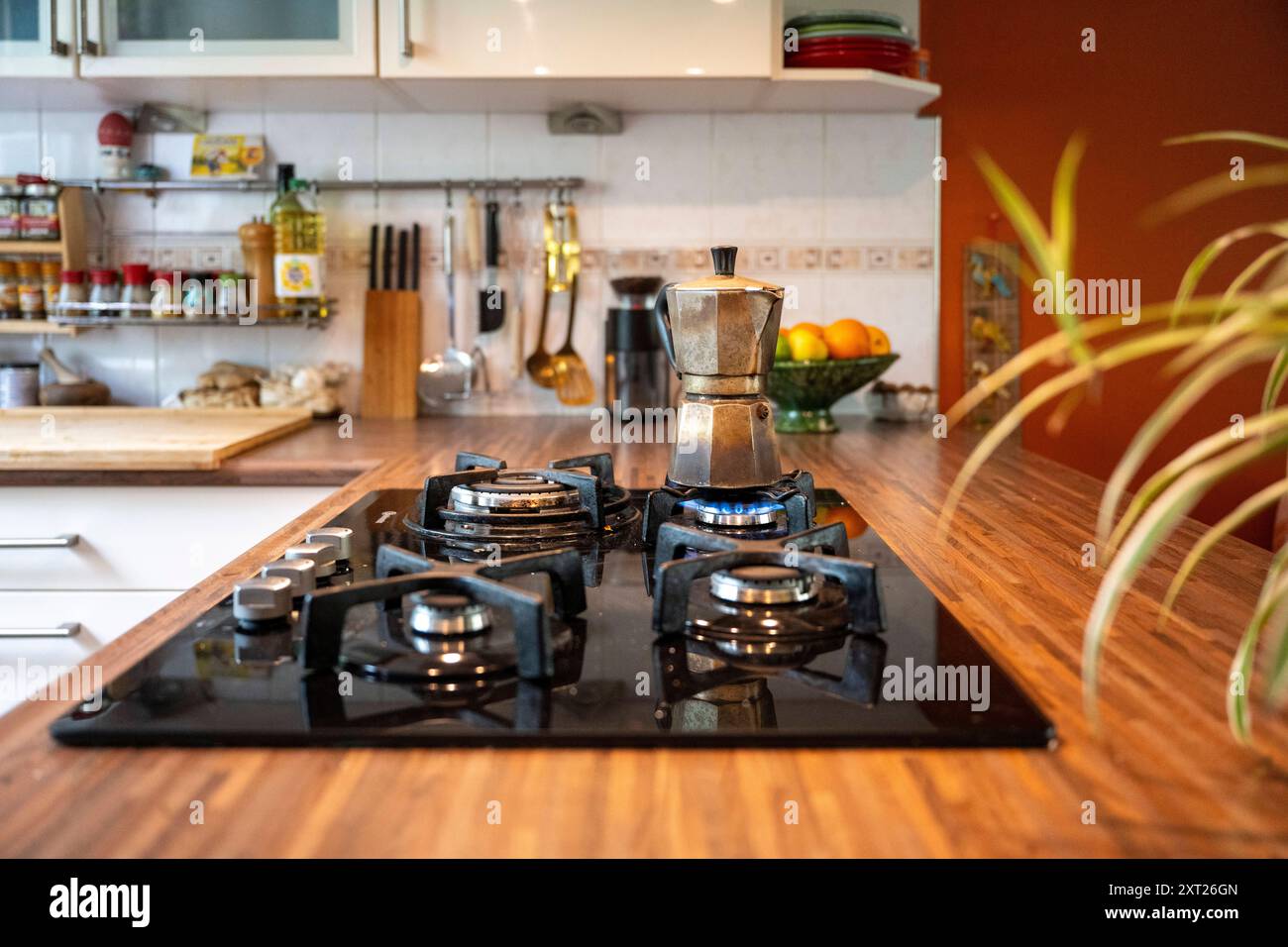 Espresso maker on a gas stove in a modern kitchen with wooden ...