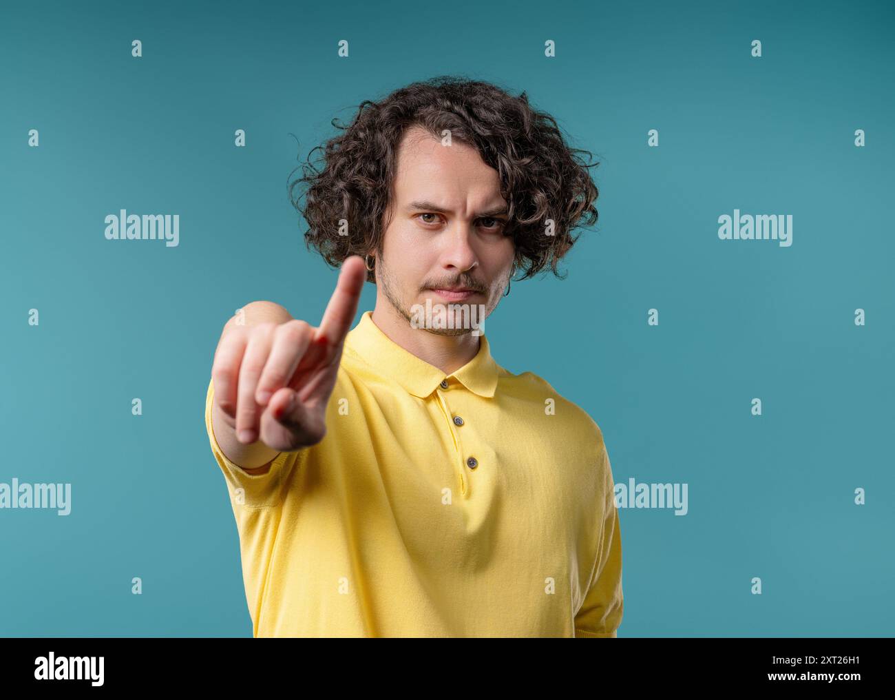 Serious Curly Man Showing Rejecting Gesture By Stop Finger Sign. Dont ...