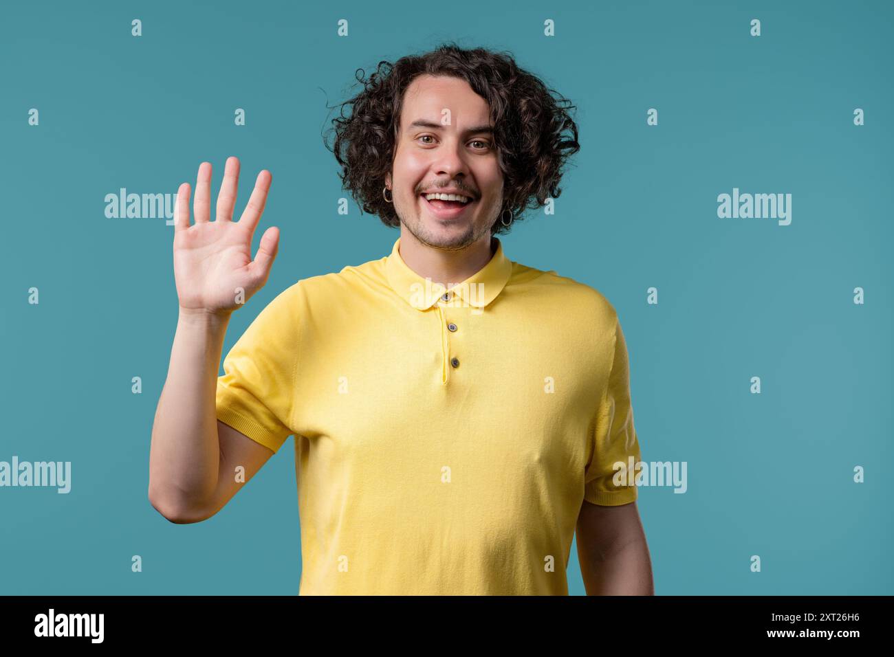 Friendly young man waving hand - hello, or goodbye, chao, salute ...