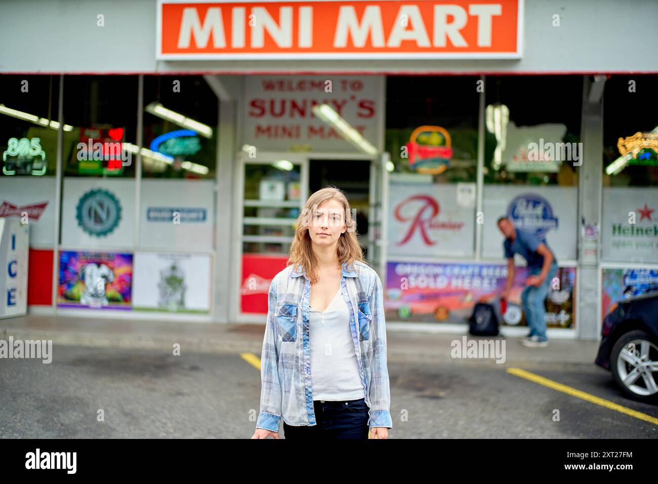 Woman standing in front of Sunny s Mini Mart with various colorful ...