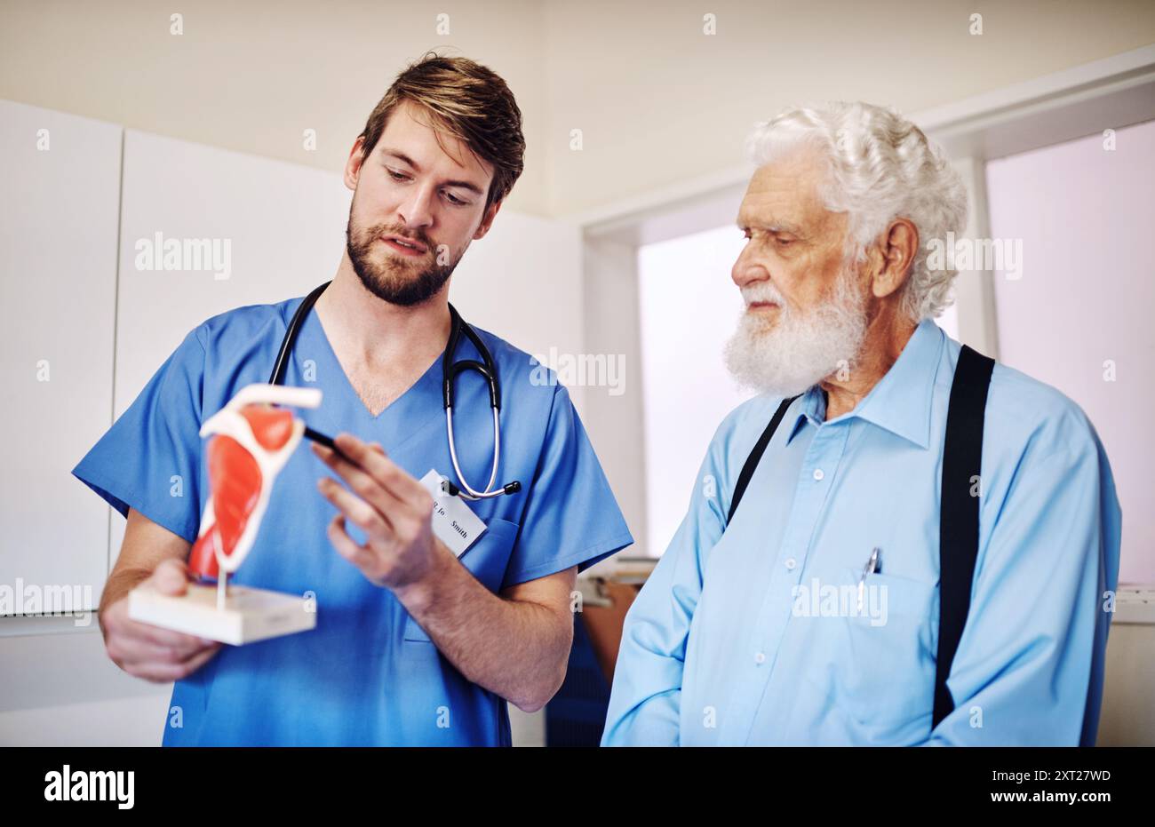 Muscle, model and doctor with senior patient for demonstration for ...