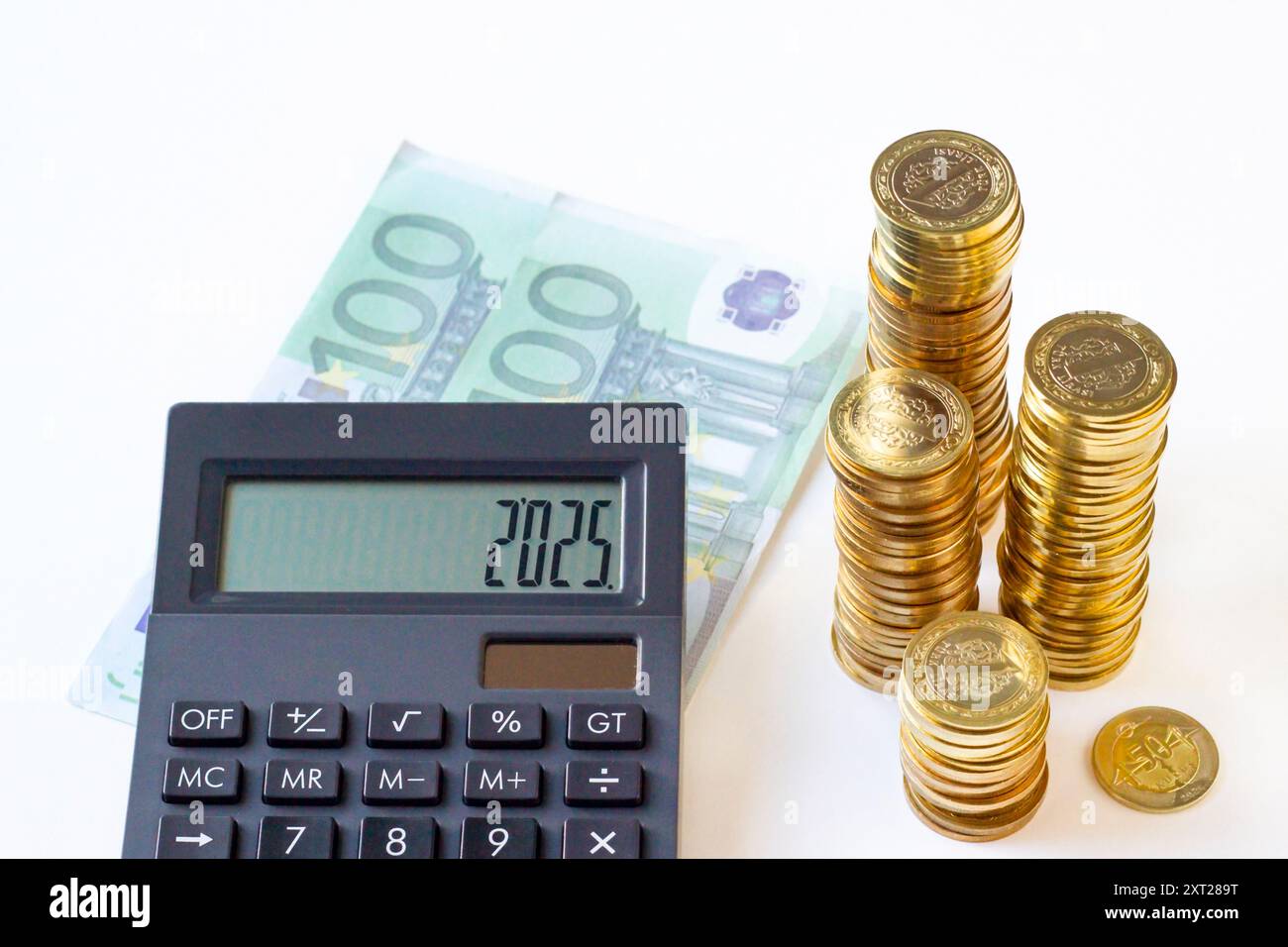 Euro Banknotes on the white surface with coins and black calculator ...