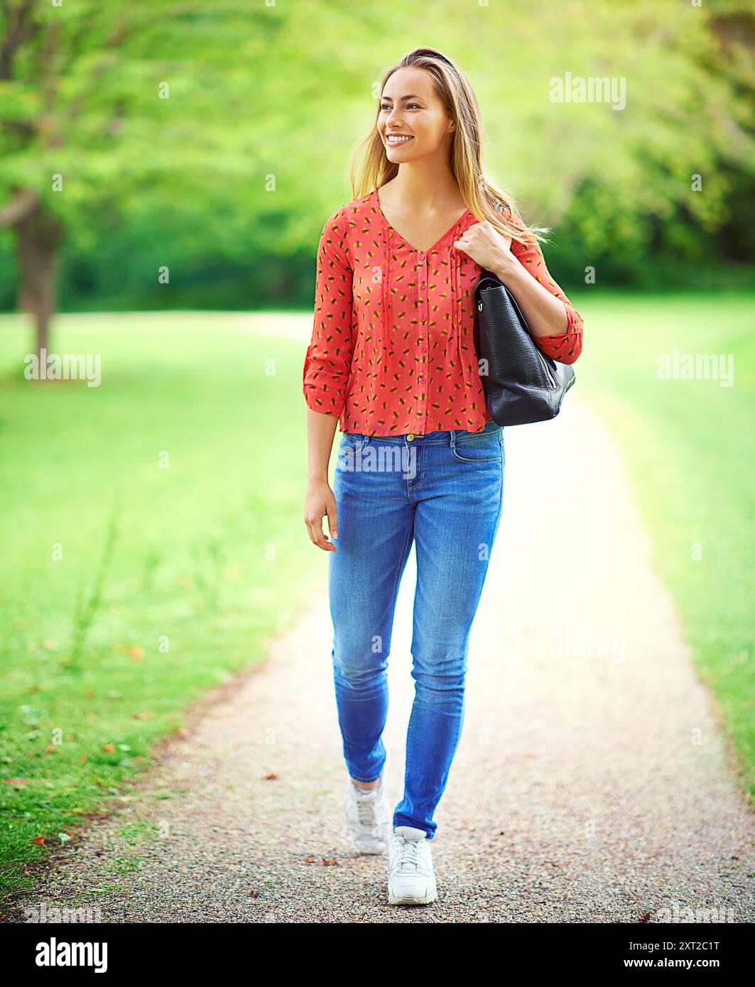 Woman, walking and path for travel in park, employee commute and happy ...