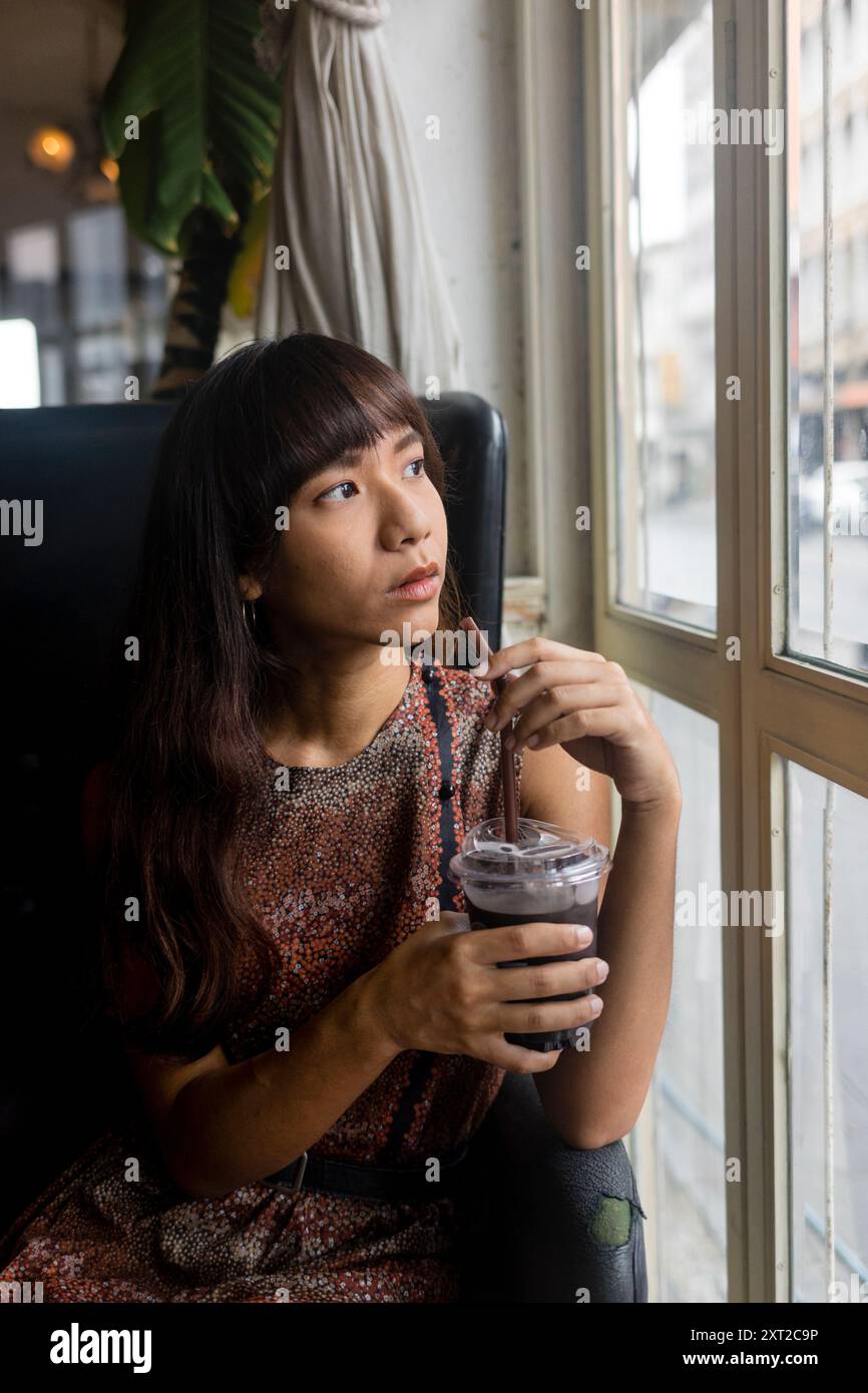 Young asian woman drinking iced tea released Stock Photo - Alamy