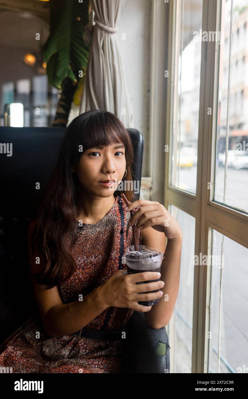 Young asian woman drinking iced tea released Stock Photo - Alamy