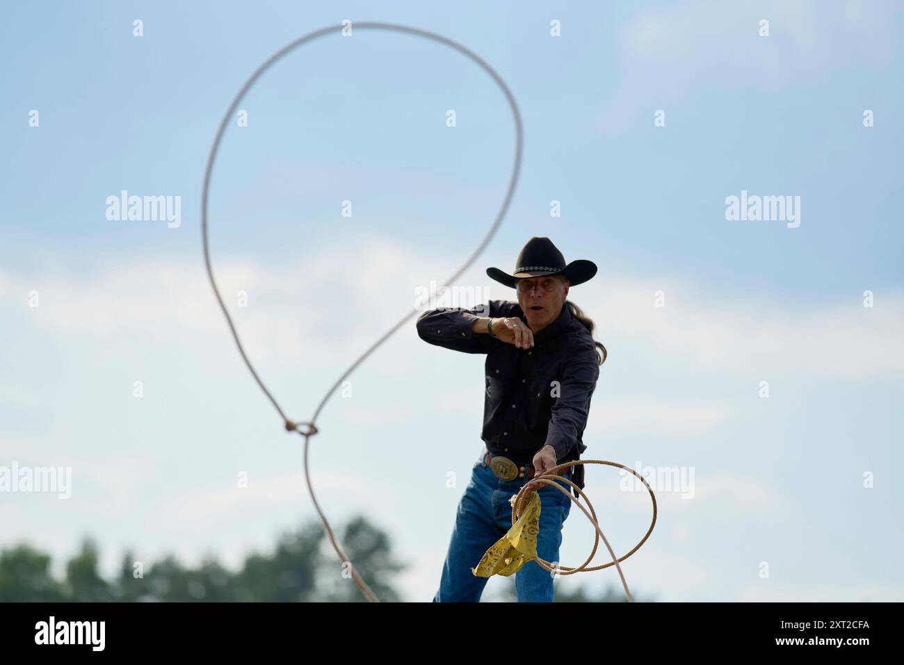 Cowboy demonstrating lasso skills under a blue sky bola03054 Copyright ...