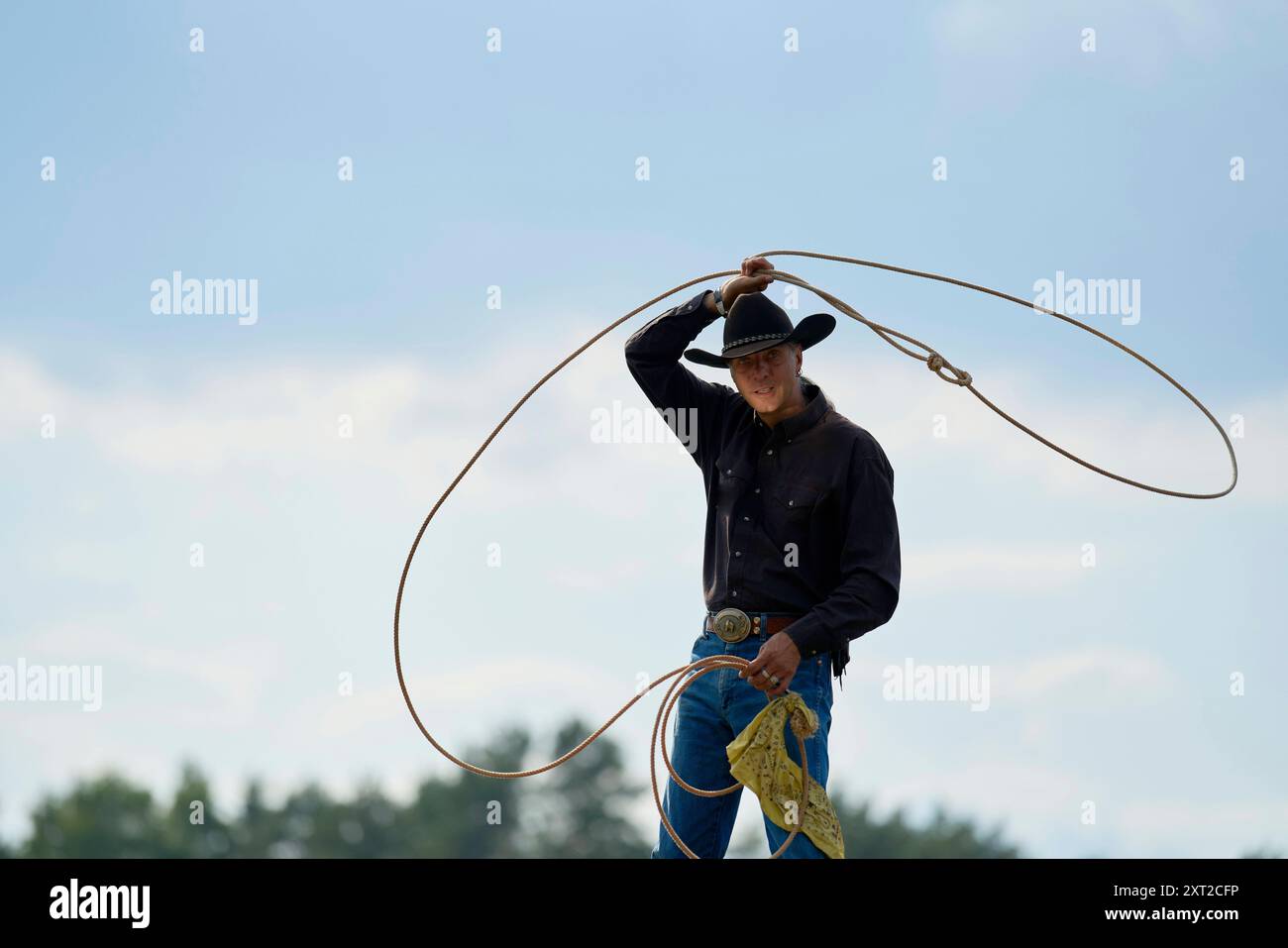 Cowboy performing a lasso trick under a cloudy sky. bola03053 Copyright ...