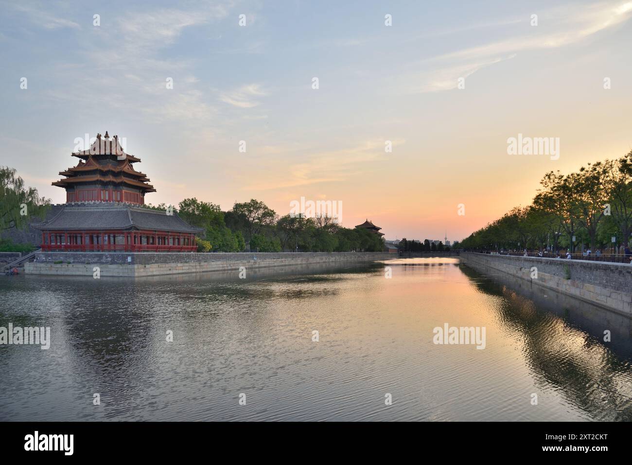 Northeastern tower of the Forbidden City reflecting in the water moat ...