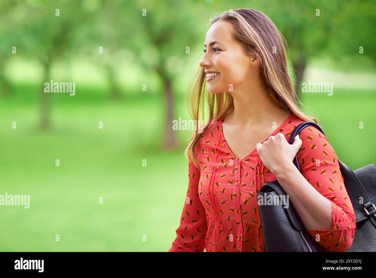 Woman, walking and smile for travel in park, employee commute and happy ...